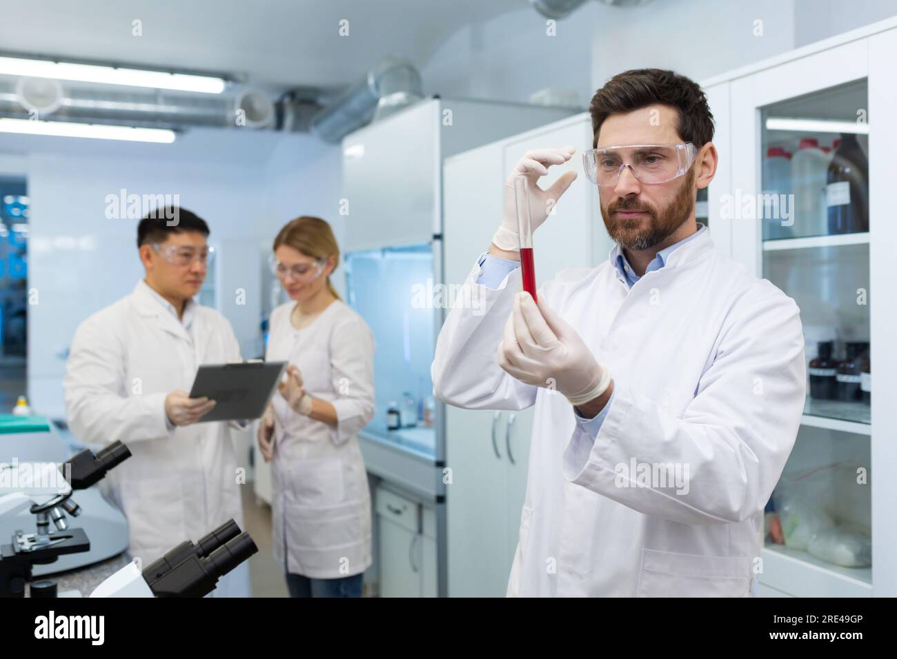 Mature experienced scientist inside laboratory researching and ...