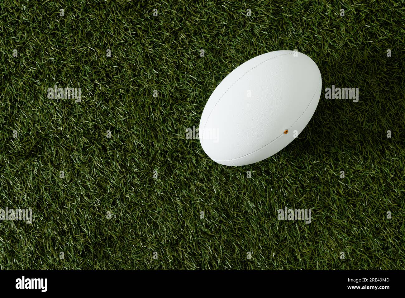 White rugby ball over grass with copy space, in slow motion Stock Photo ...