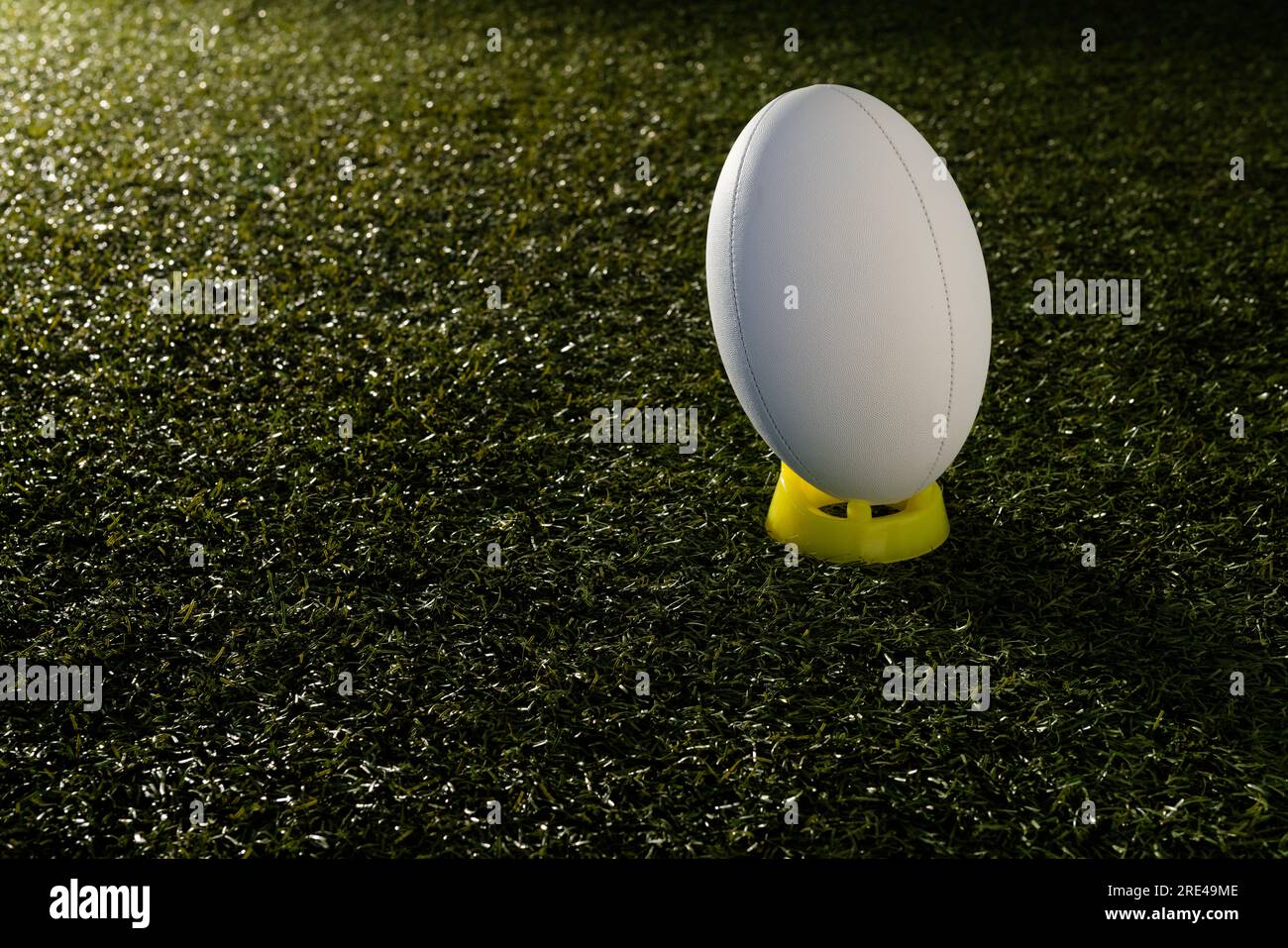 White rugby ball over grass with copy space, in slow motion Stock Photo ...