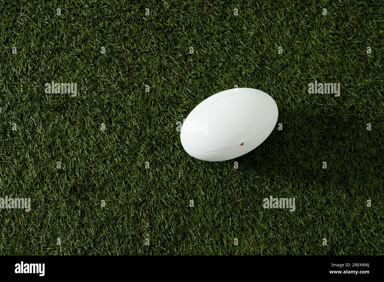 White rugby ball over grass with copy space, in slow motion Stock Photo ...