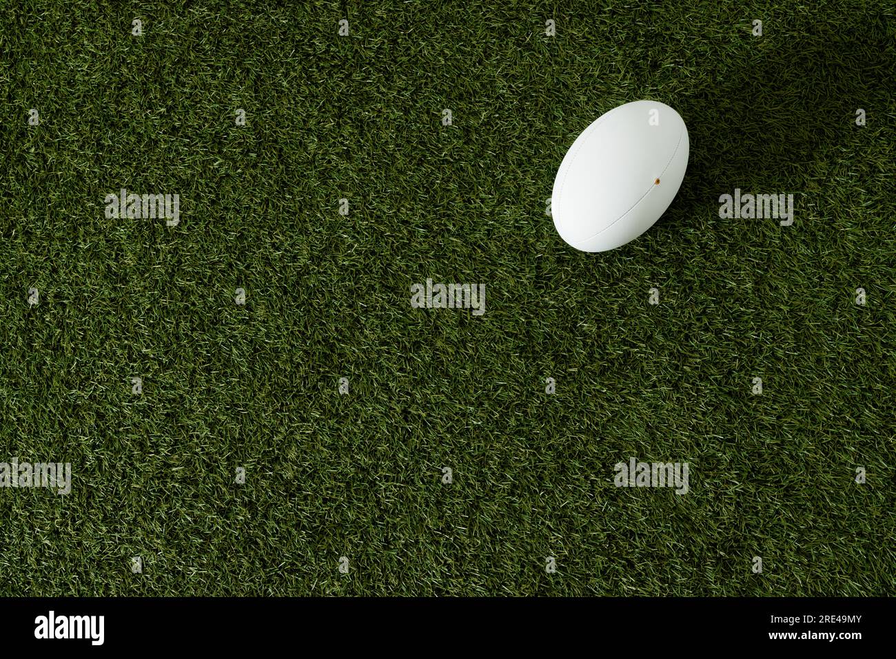 White rugby ball over grass with copy space, in slow motion Stock Photo ...