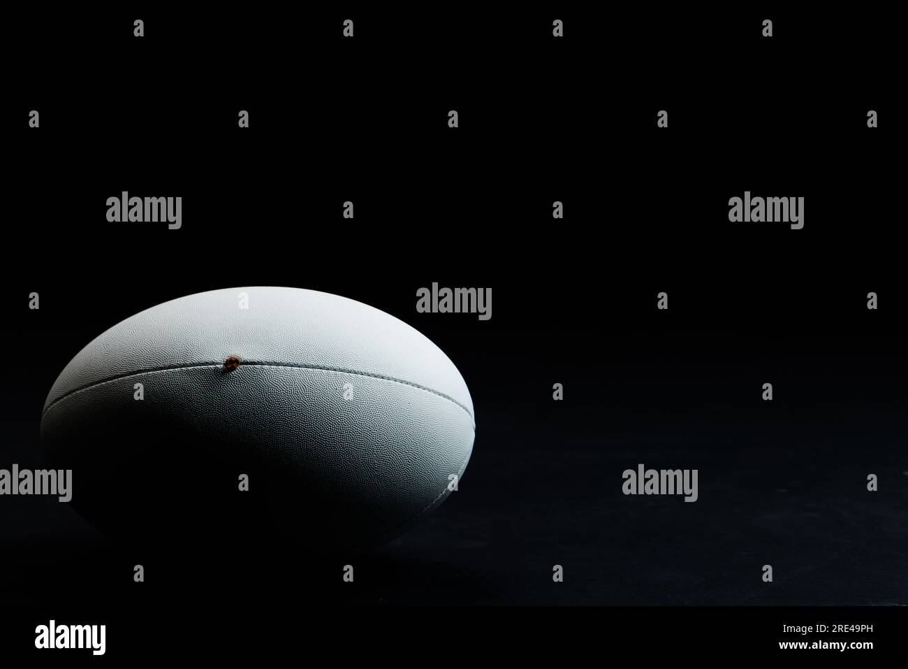White rugby ball with copy space on black background Stock Photo - Alamy