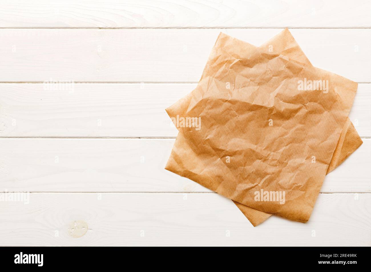 top view with baking parchment empty on table background. Folded cloth ...