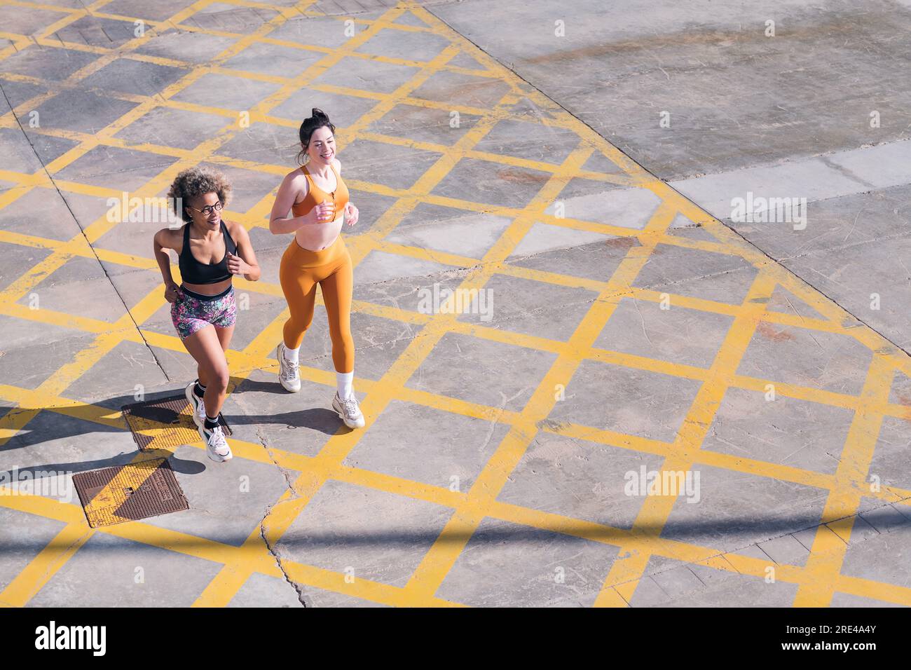 Two women running along road hi-res stock photography and images - Alamy