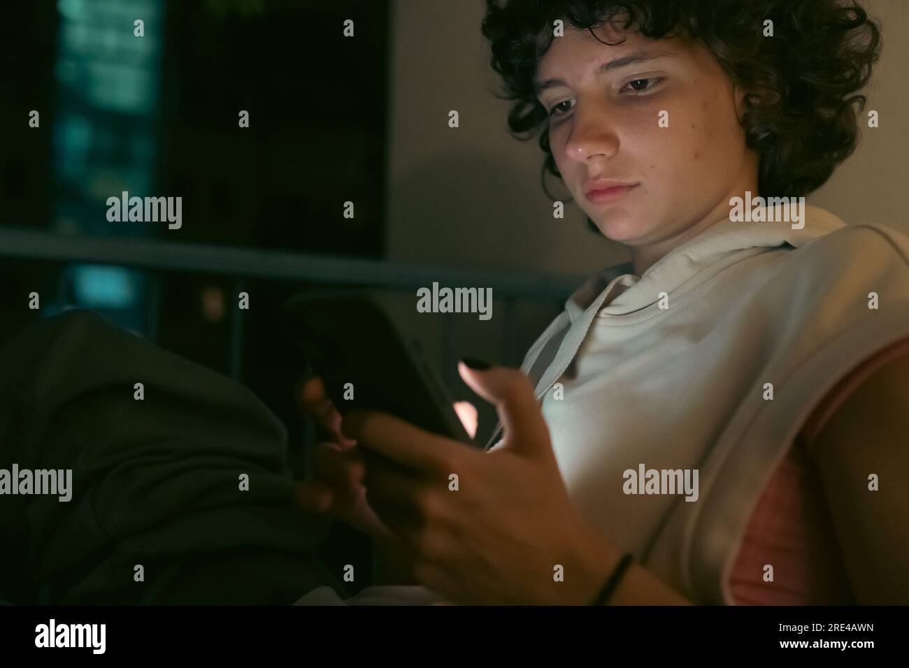 using mobile apps technology on cell phone late at night Stock Photo ...