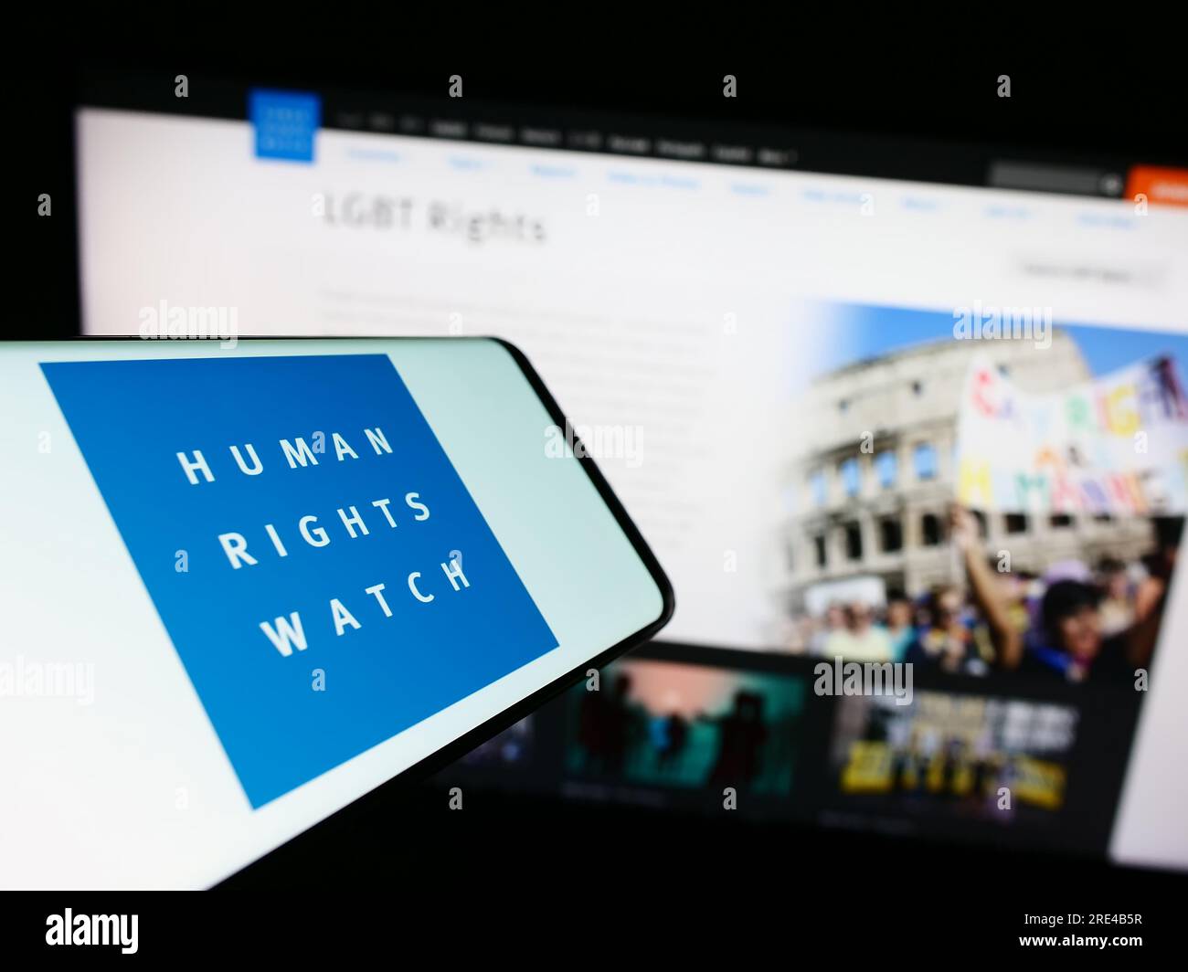 Cellphone with logo of organization Human Rights Watch (HRW) on screen ...