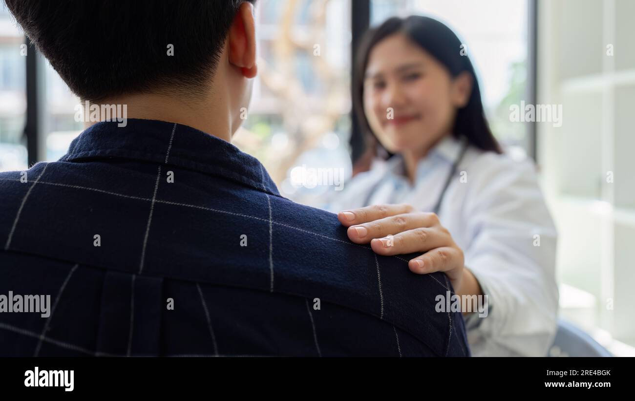 young woman Asian doctor patient, patting shoulder with care, support ...