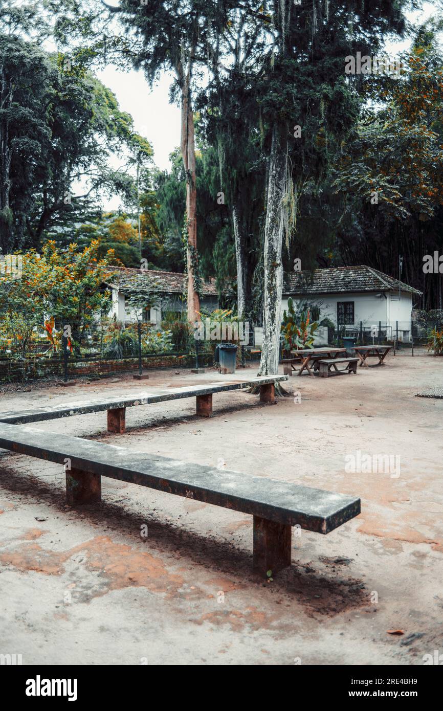A vertical wide-angle shot of low concrete benches in the middle of a ...