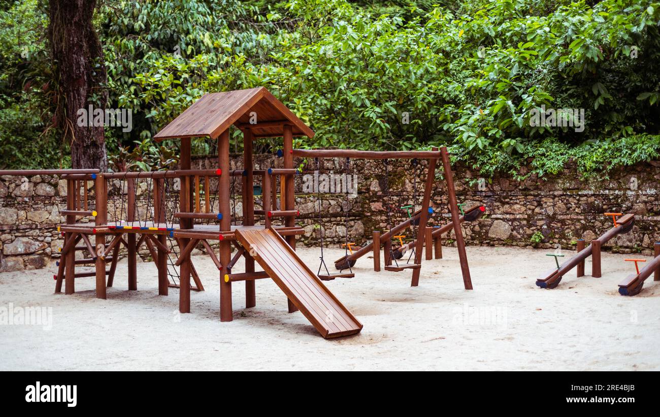 View of a children's playground in a tropical park with a group of ...