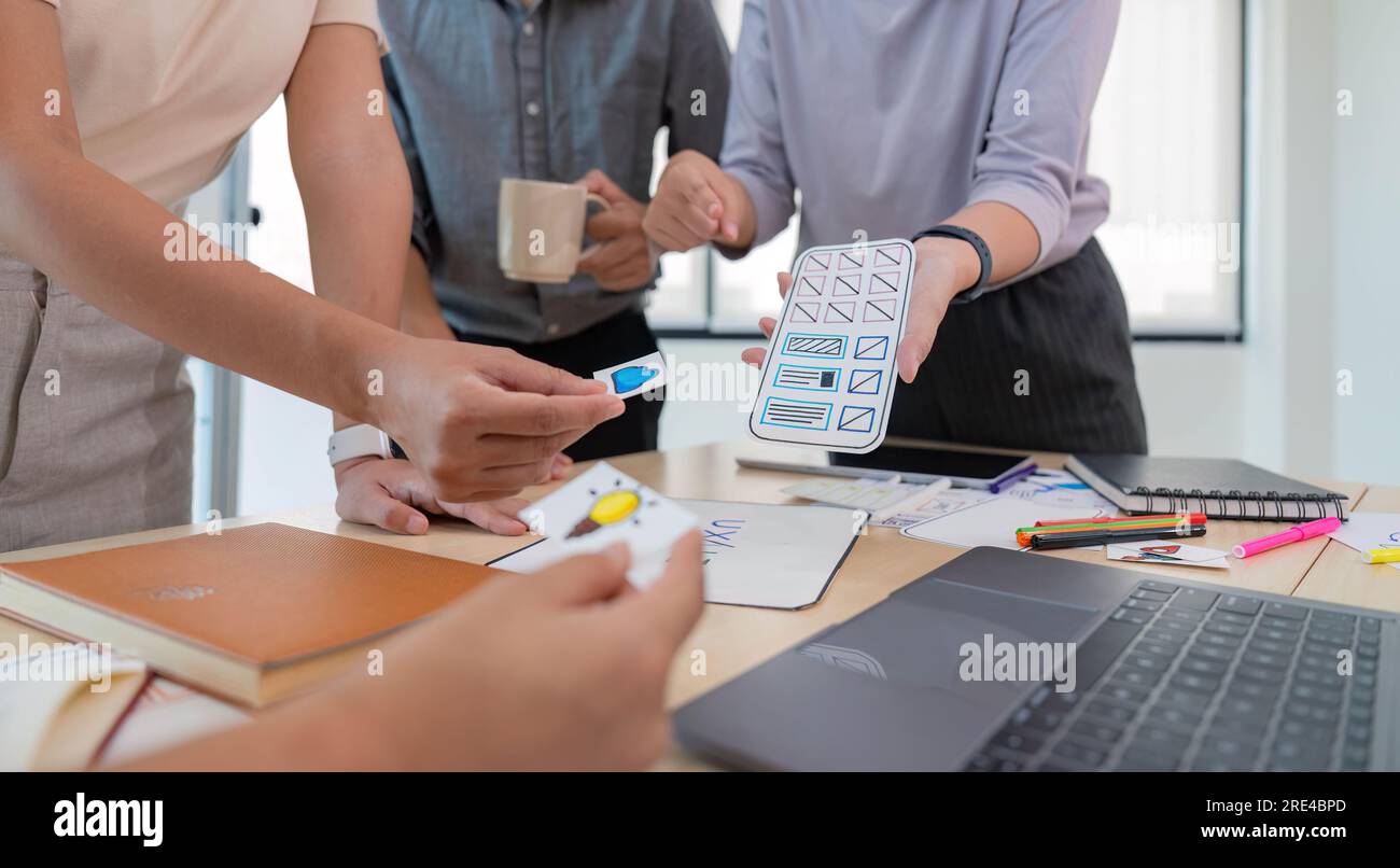 Close up ux developer and ui designer brainstorming interface wireframe ...