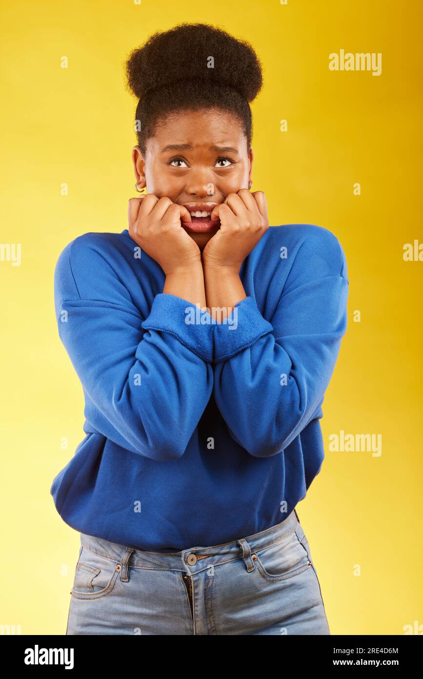 Anxiety, fear and black woman biting nails in studio with terror, guilt ...