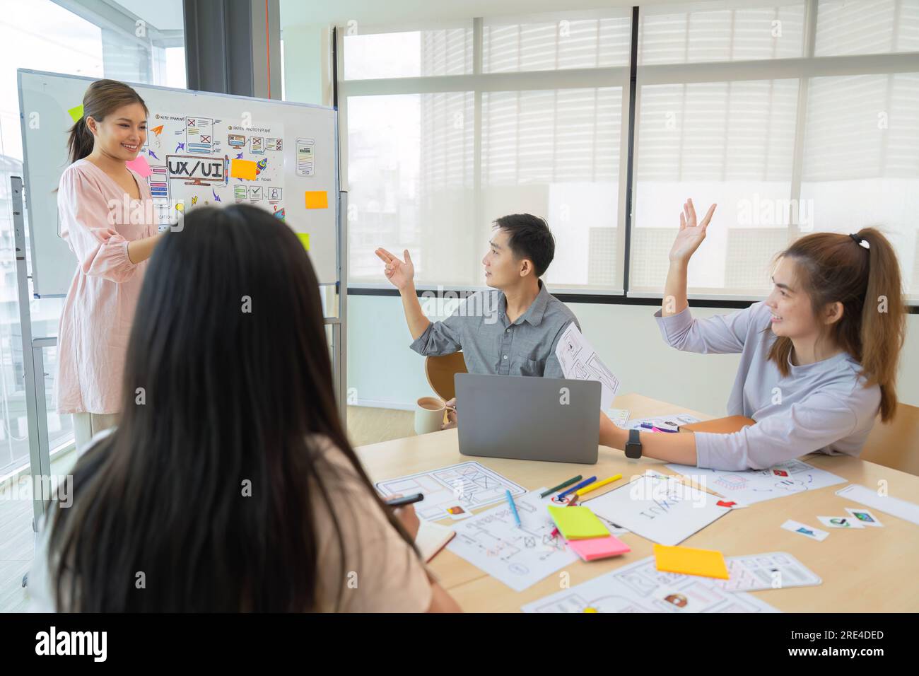 ux developer and ui designer presenting and testing mobile app ...