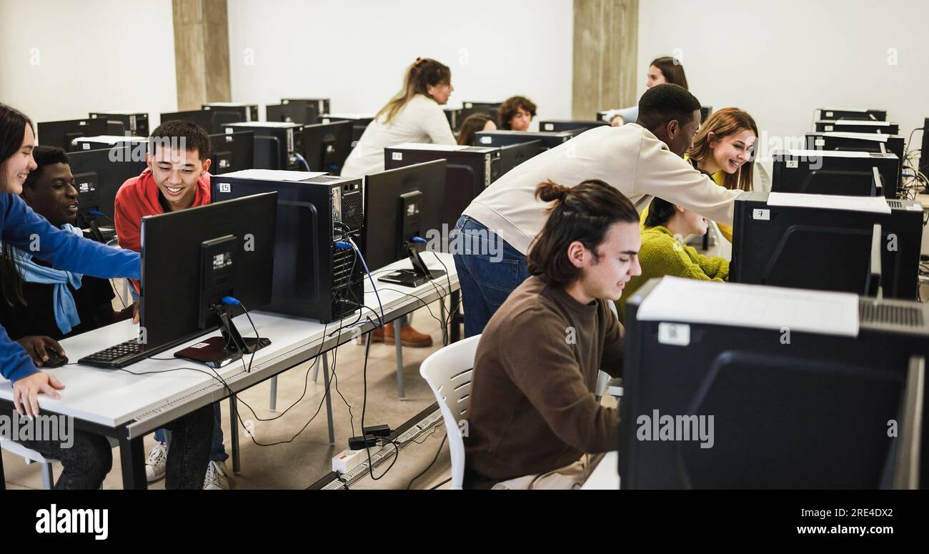 Young students using personal computer inside university IT class ...