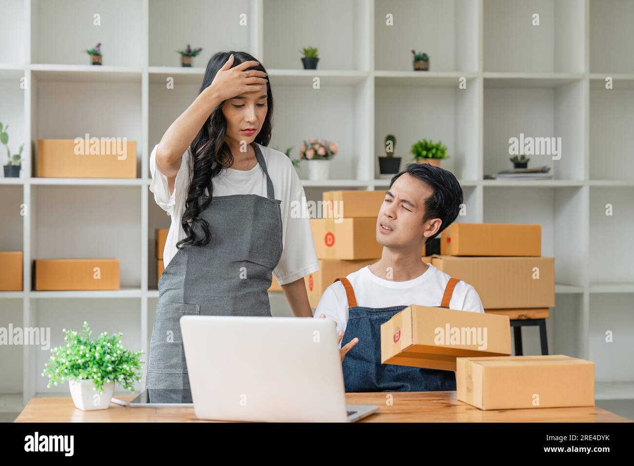 Portrait of young asian couple stressed because they have to respond to ...