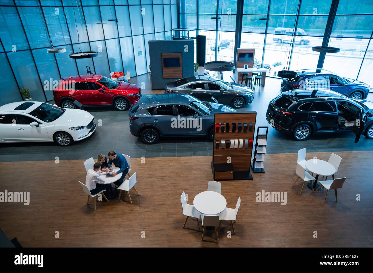 Happy caucasian couple signs a contract for the purchase of a car salon ...