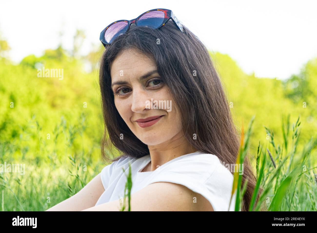 Portrait of a 35-year-old brunette woman looking at the camera smiling ...