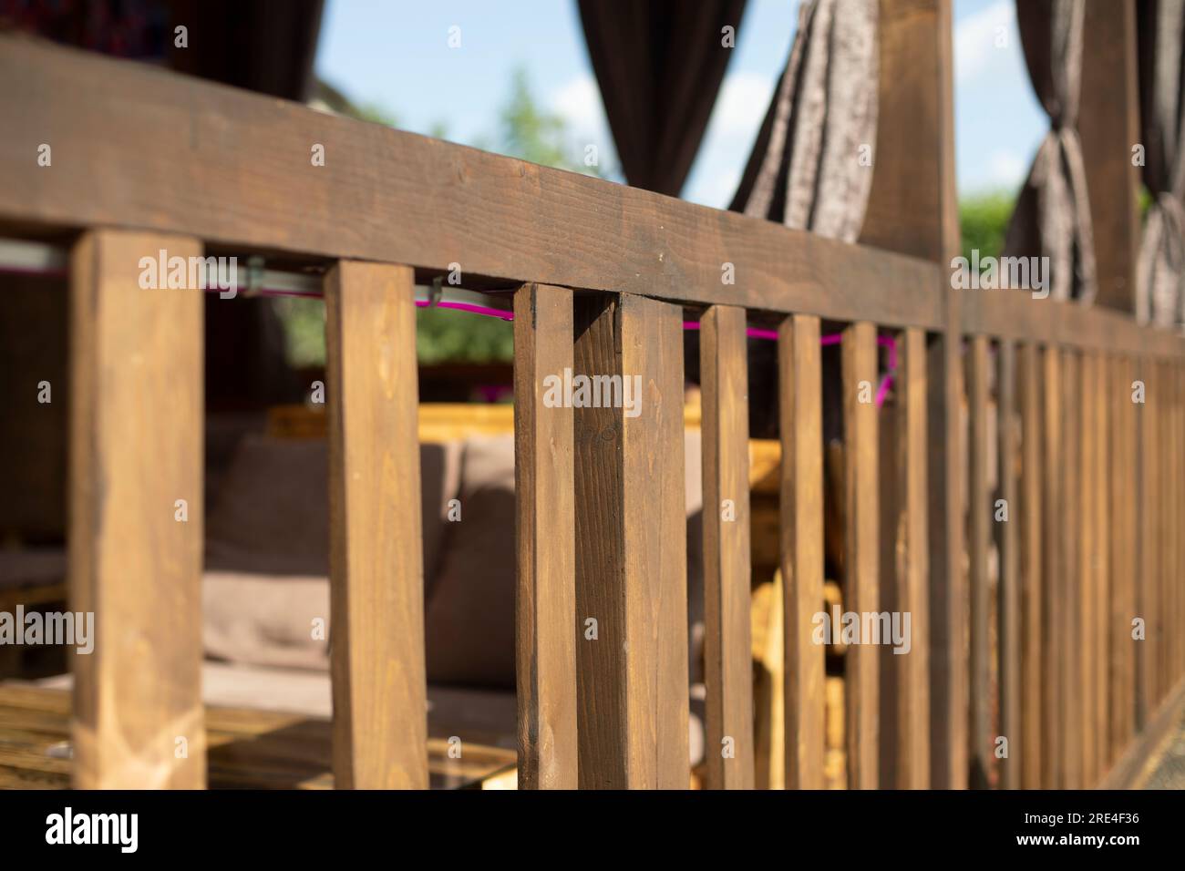 Veranda made of wood. Fence from boards. Street restaurant. Brown fence ...