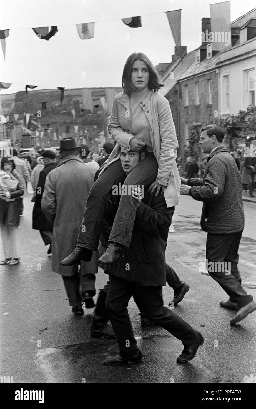 Couple having fun, girl riding on boyfriends shoulders. Helston Furry ...