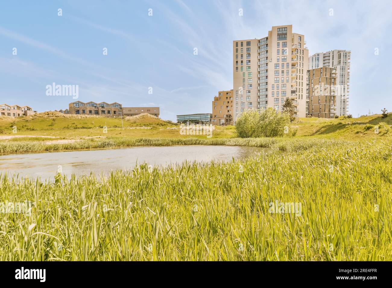 some tall buildings in the distance, with green grass growing on the ...