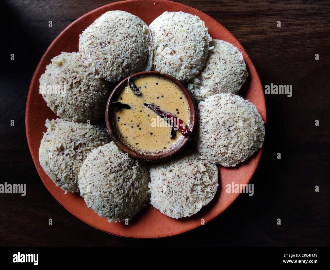Millet idli idly with coconut chutney in a clay plate hi-res stock ...