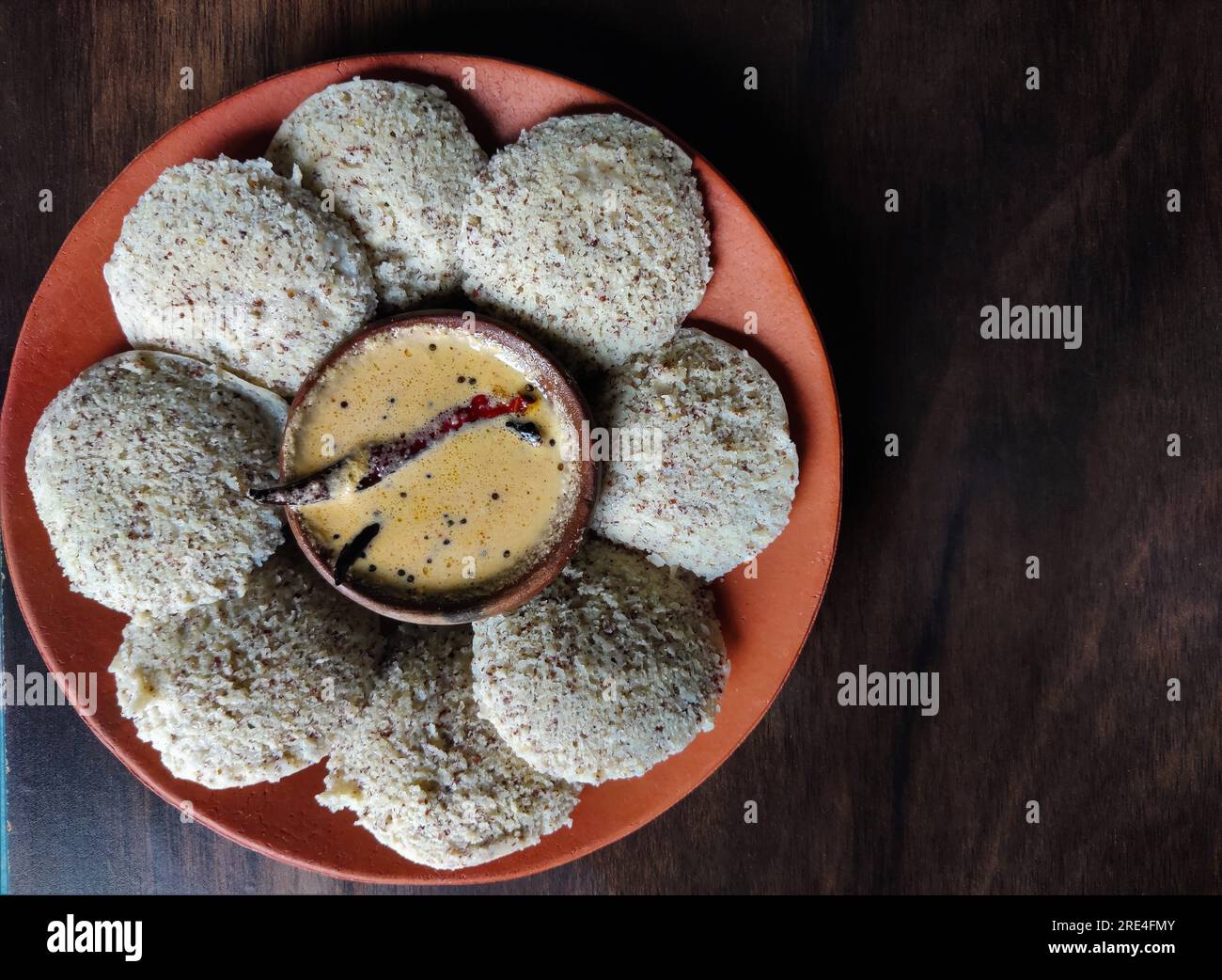 Millet idli idly with coconut chutney in a clay plate hi-res stock ...