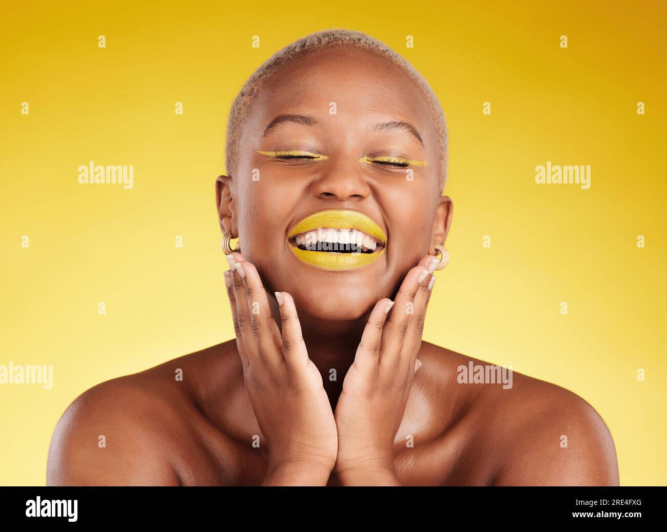 Happy, gold makeup and a black woman on a studio background for ...
