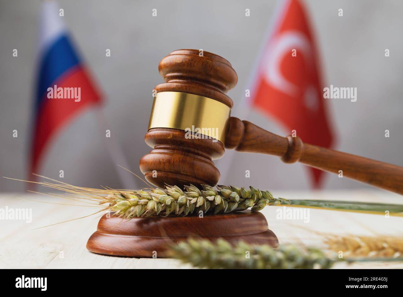 Hammer, wheat, barley ears and flags of countries on the table, a ...