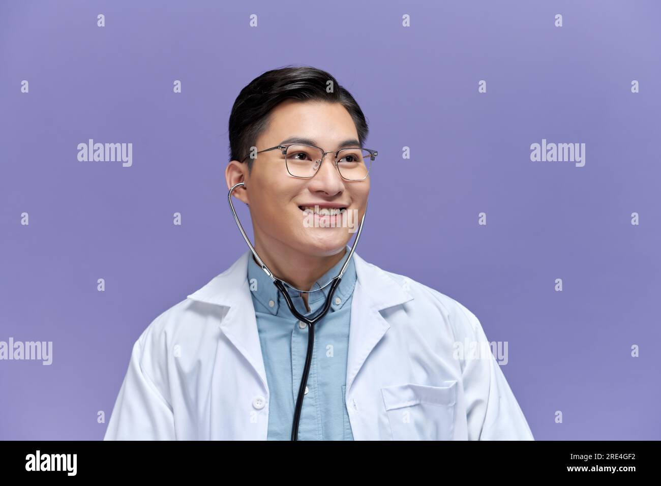 Portrait of confident positive smiling asian male doctor wearing ...