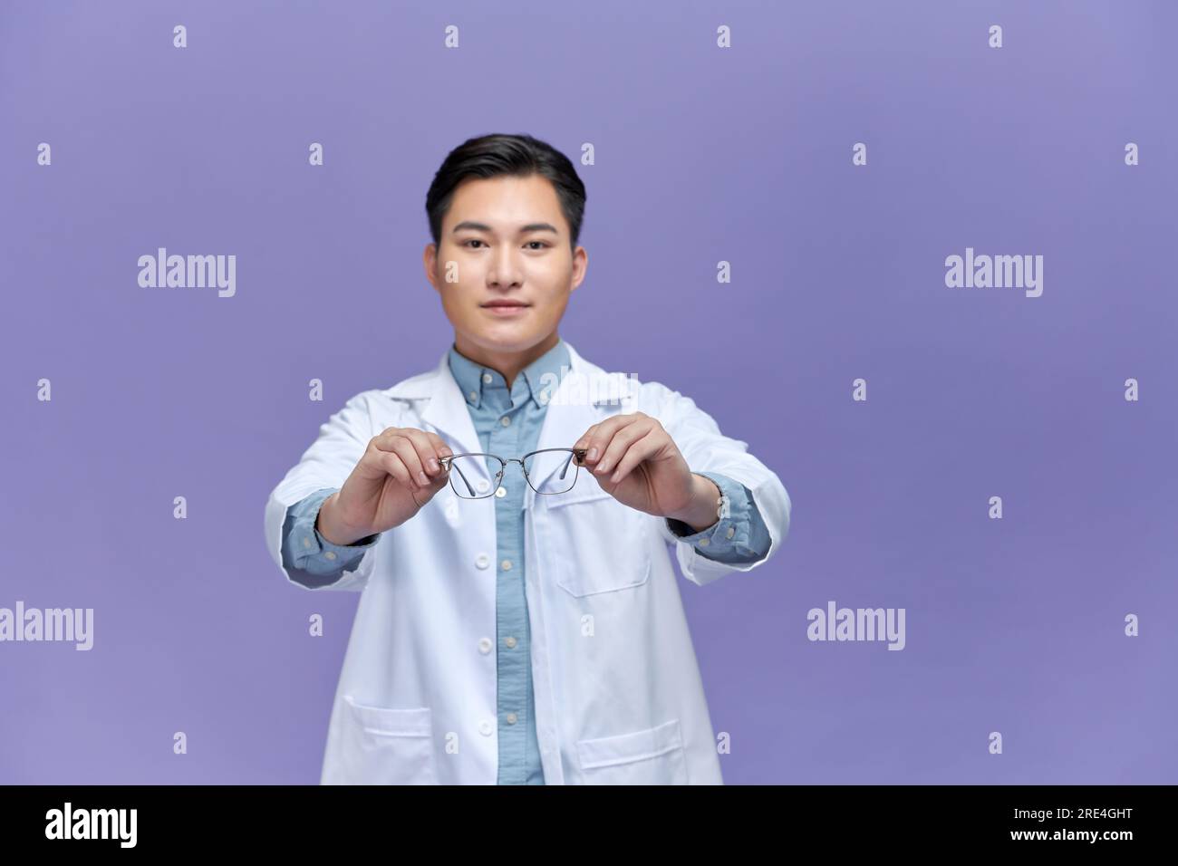 Happy asian ophthalmologist doctor holding glasses, recommending to ...