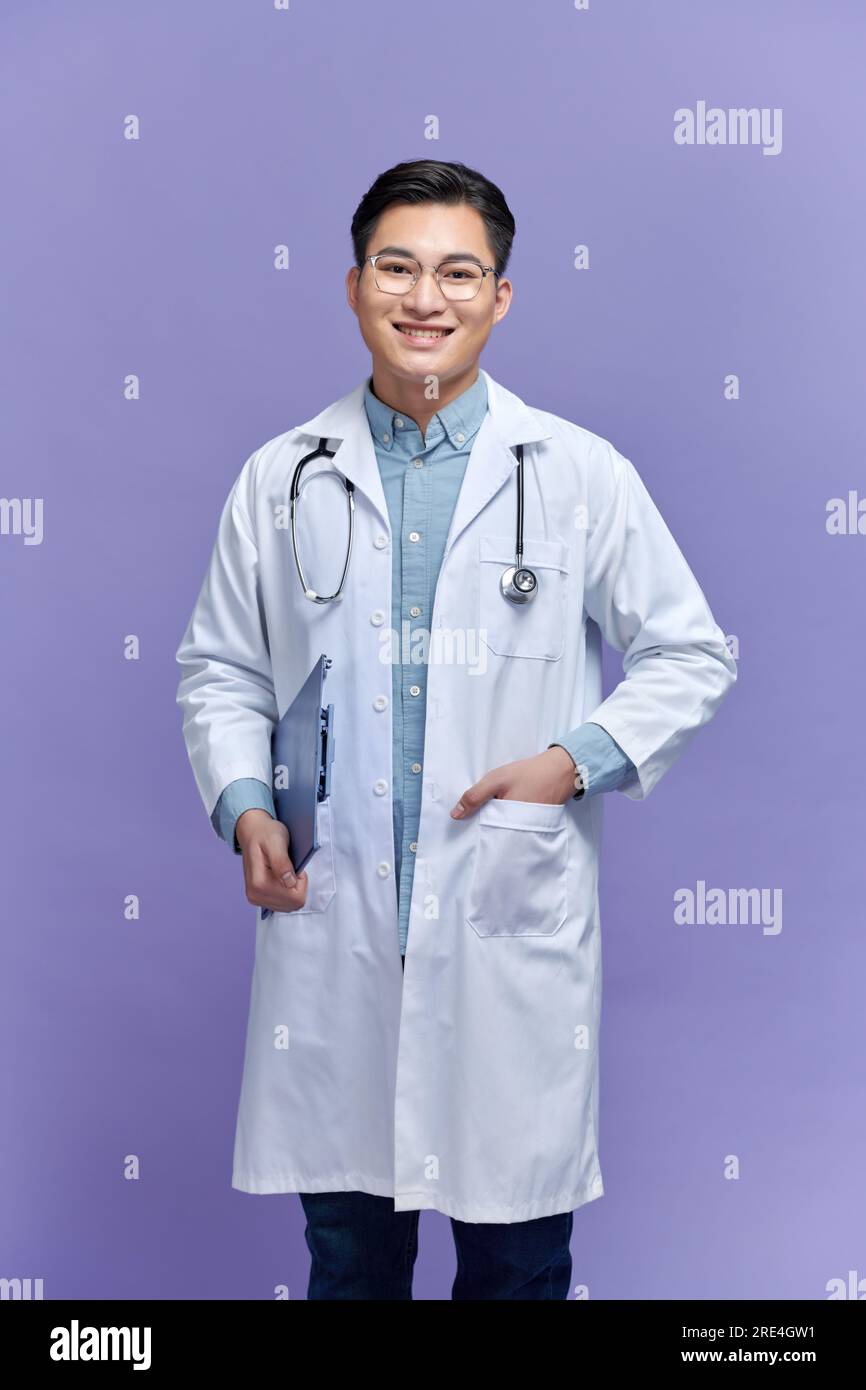 A handsome doctor wearing white lab coat and stethoscope smiling ...