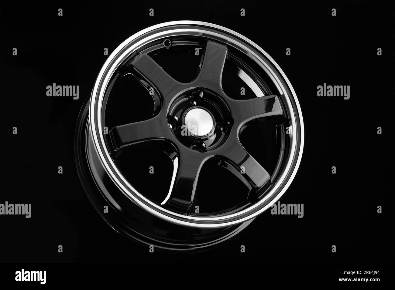Stylish black die-cast disc for sports design cars on a black ...