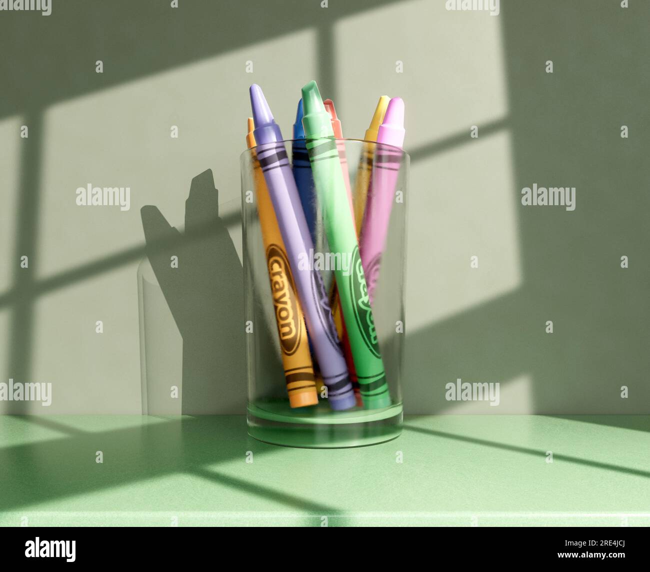 A concept showing a few colorful childrens wax crayons in a glass on a ...