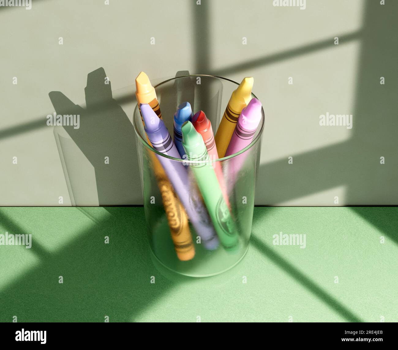 A concept showing a few colorful childrens wax crayons in a glass on a ...