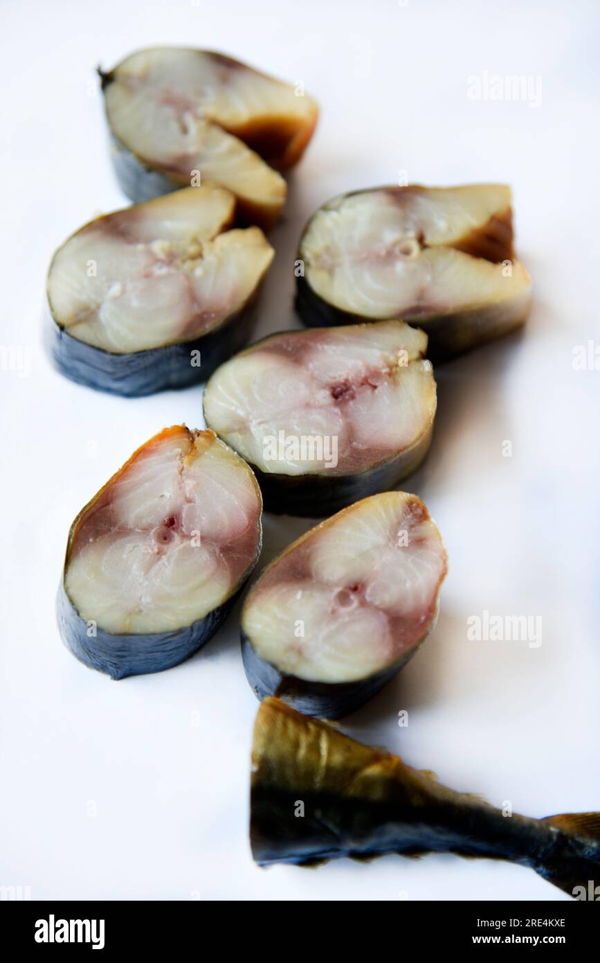 Cold smoked mackerel cut into slices on a white background. Top view ...
