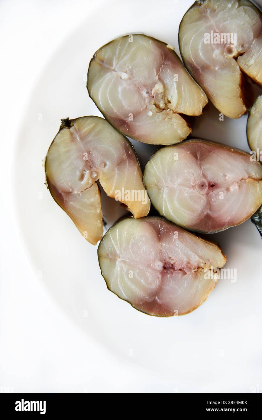 Cold smoked mackerel cut into slices on a white background. Top view ...