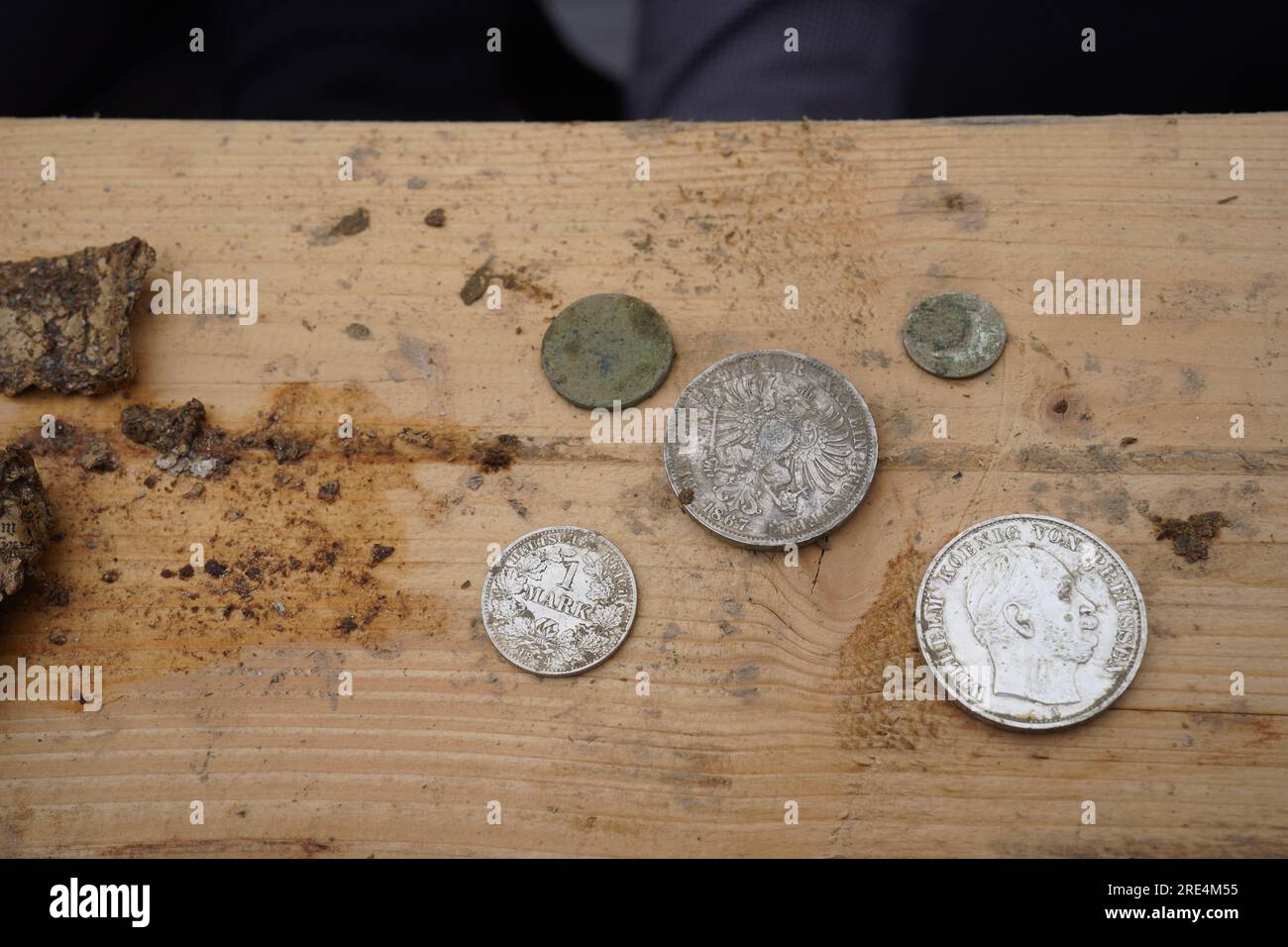 Eutin, Germany. 25th July, 2023. Coins and a rotten and damp newspaper ...