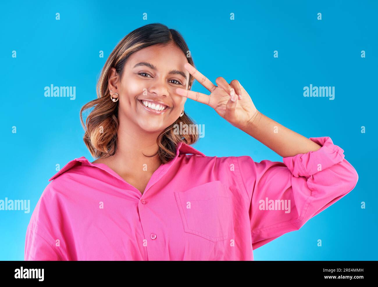 Smile, happy and peace sign with portrait of woman in studio for ...
