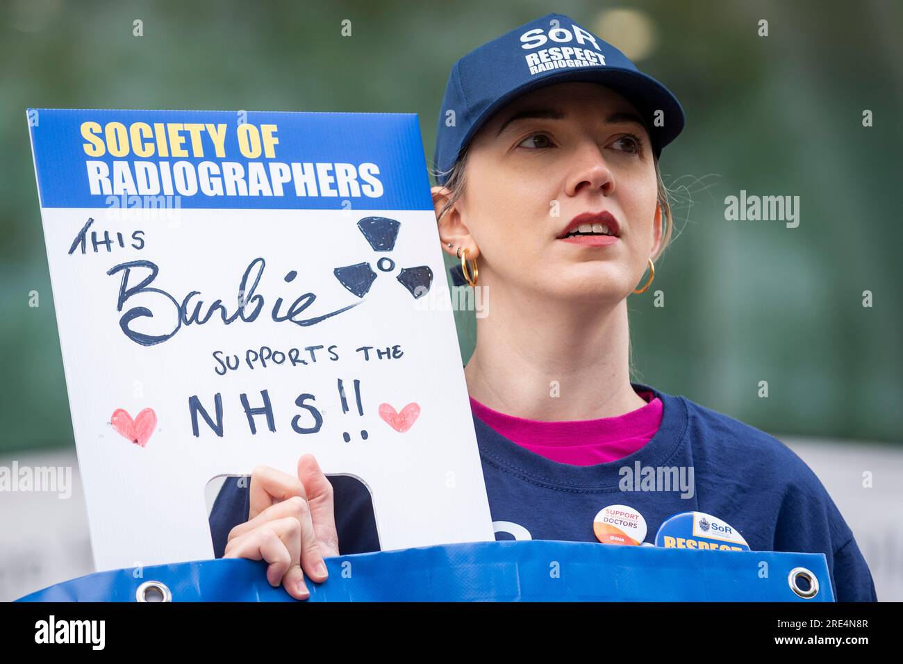 London, UK. 25 July 2023. A radiographer at a picket line outside ...