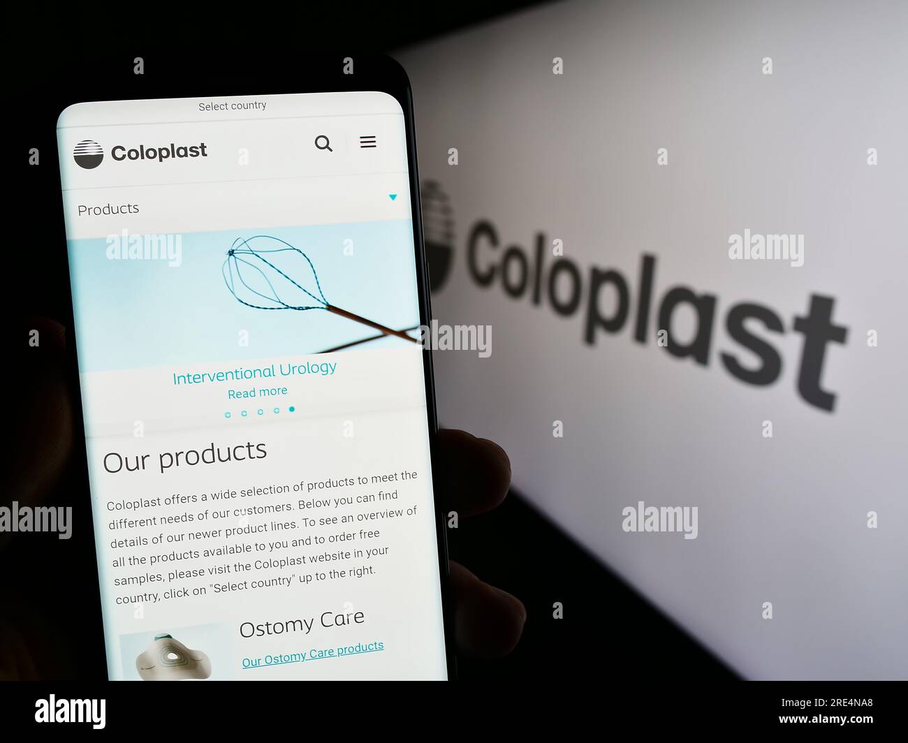 Person holding cellphone with webpage of Danish healthcare company ...