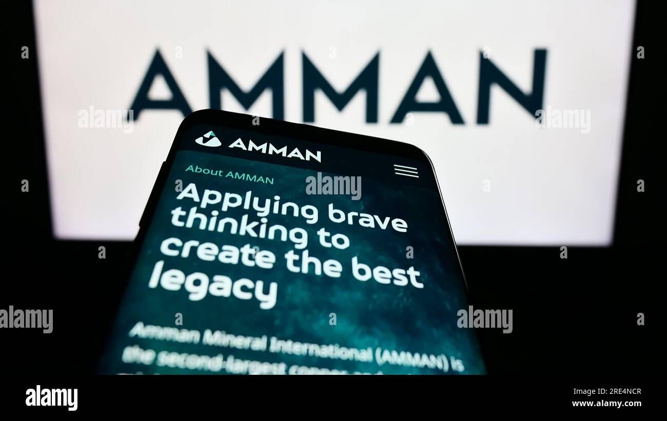 Mobile phone with website of company PT Amman Mineral Internasional Tbk ...