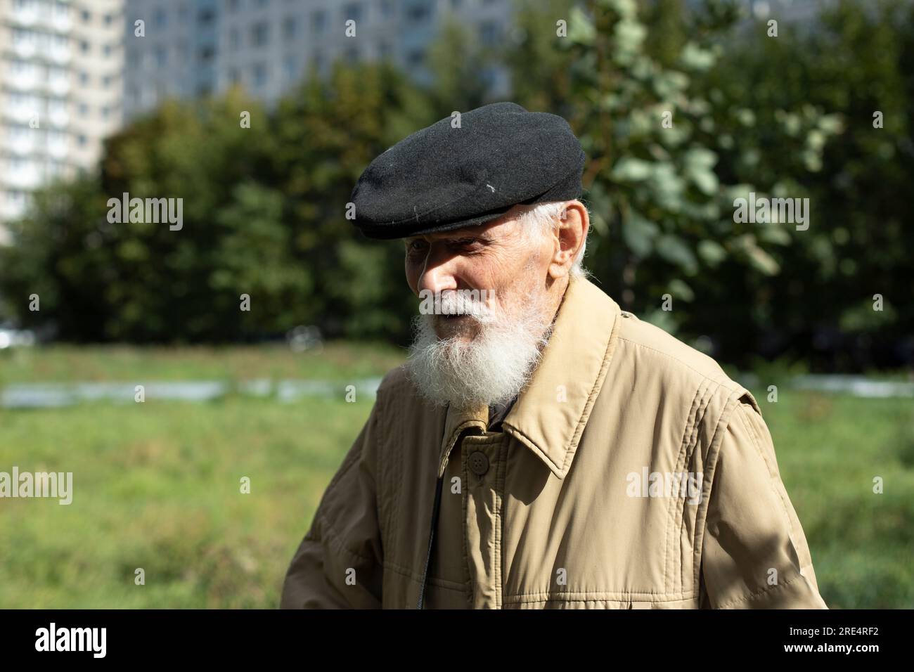 Old man with gray beard. Pensioner on street. Old-fashioned headdress ...