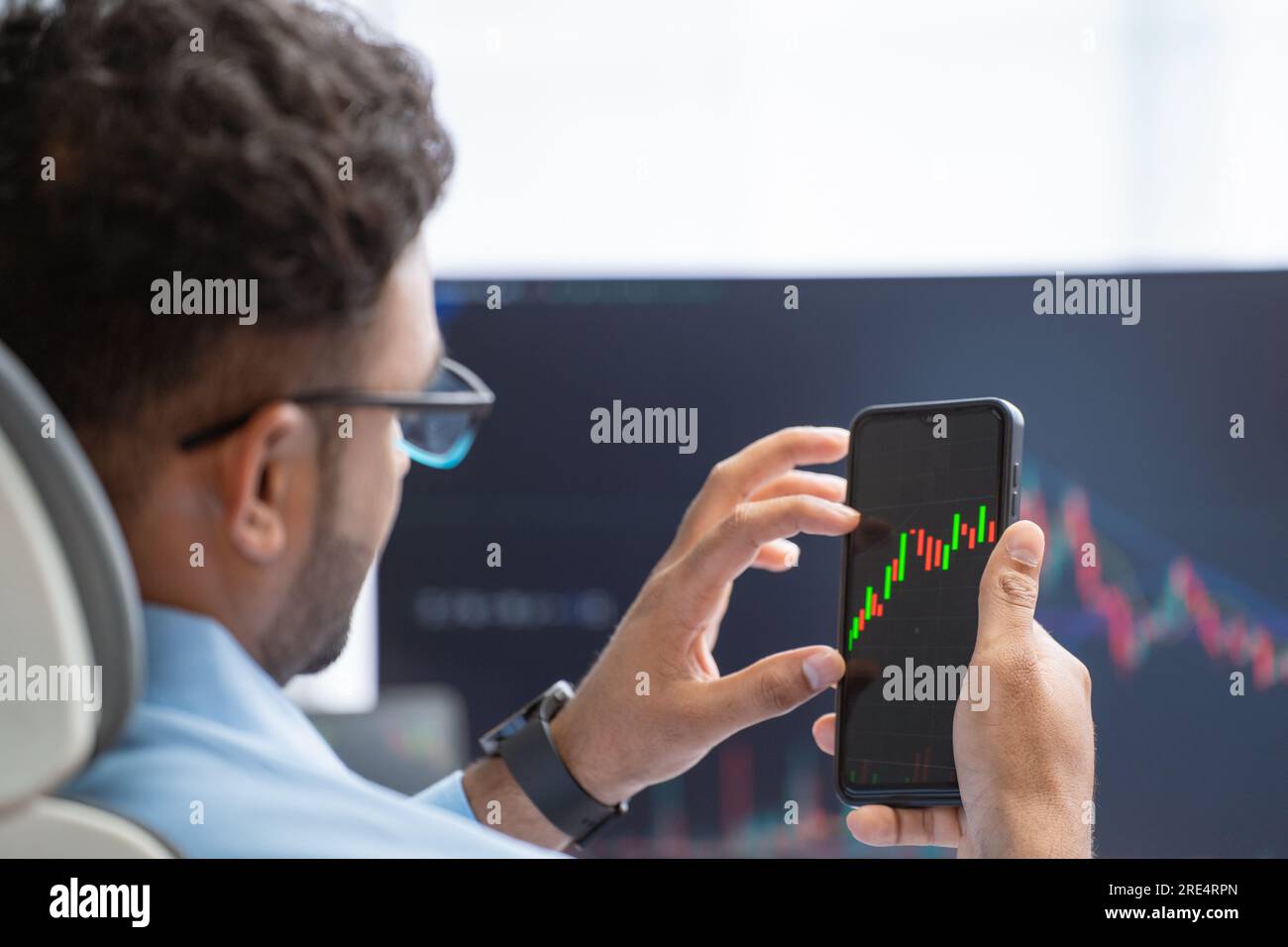 Shoulder shot of indian stock Market broker or trader checking charts ...