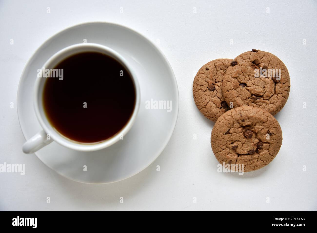 Tea pair and oatmeal cookies with chocolate on a white background ...