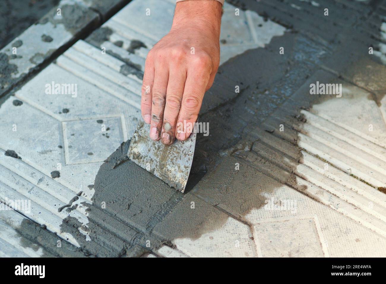 A carpenter repairs a building with tools at a construction site. The ...