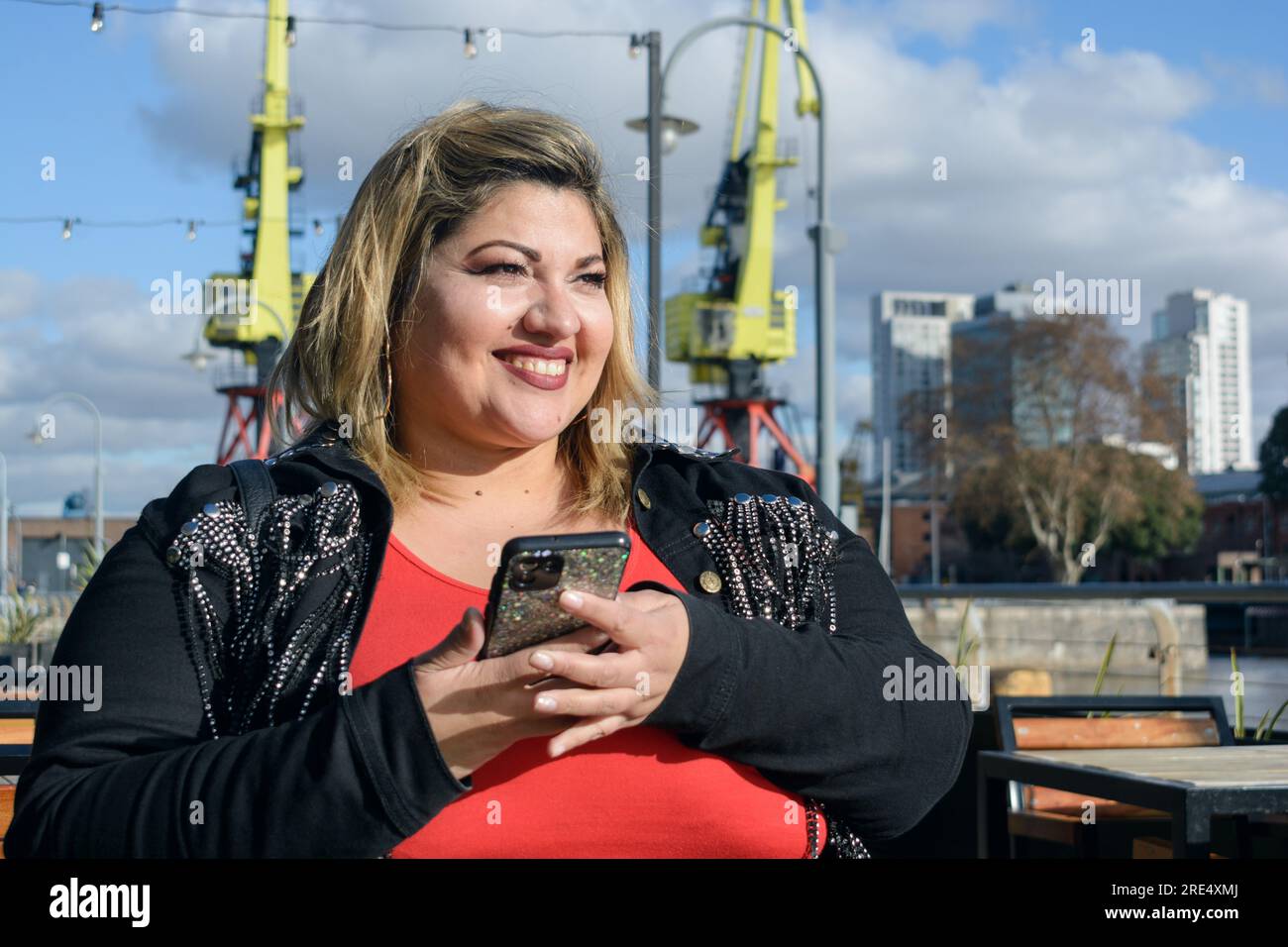 young plus size argentinian latin woman sitting outside a restaurant ...