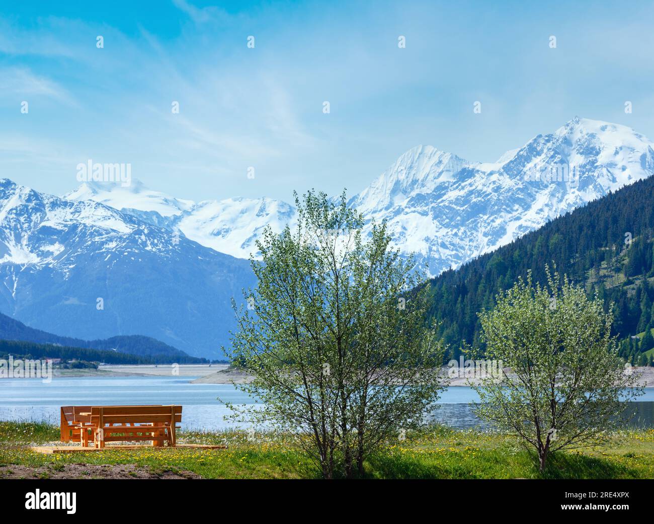 Reschensee ( or Lake Reschen) summer landscape with blossoming meadow ...