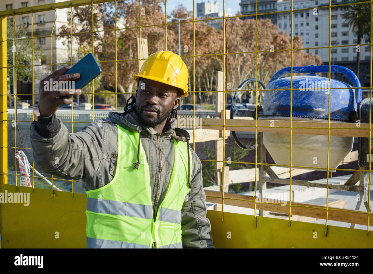 young african man with beard, yellow safety helmet and reflective vest ...