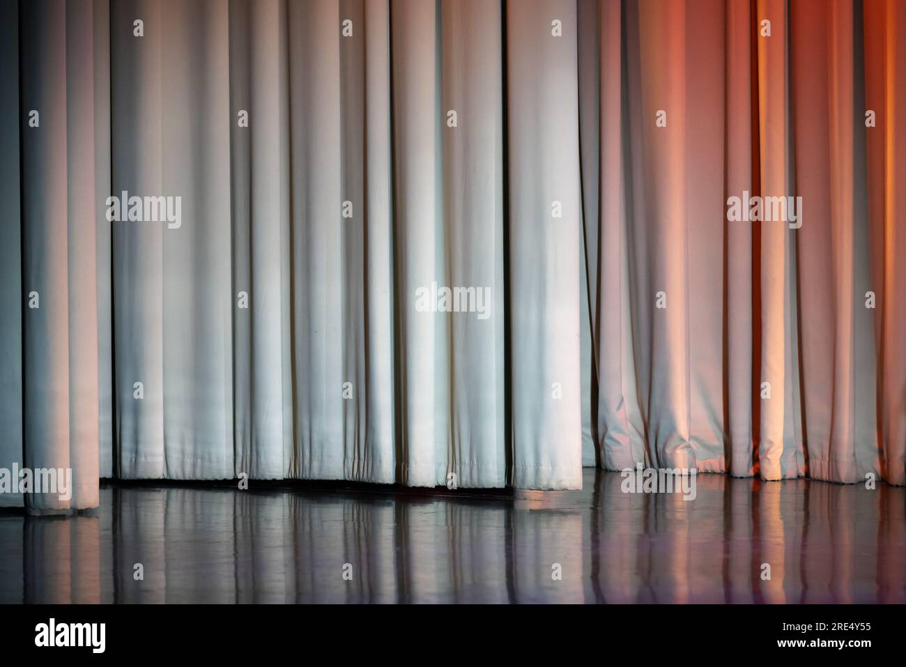 Closed white wavy curtain hangs over an empty stage, background photo ...