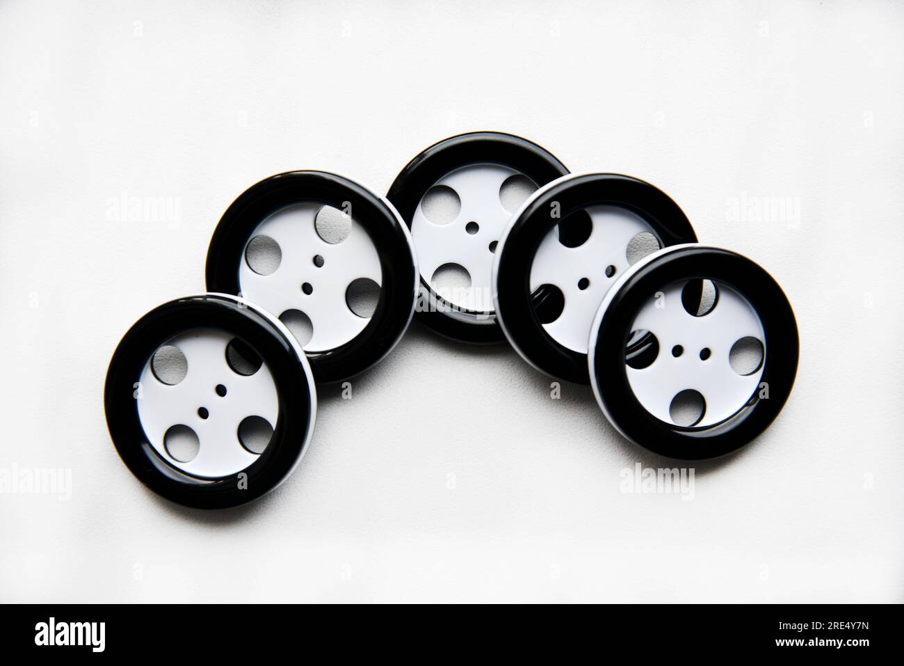 Large black and white buttons with clothes on a white background ...