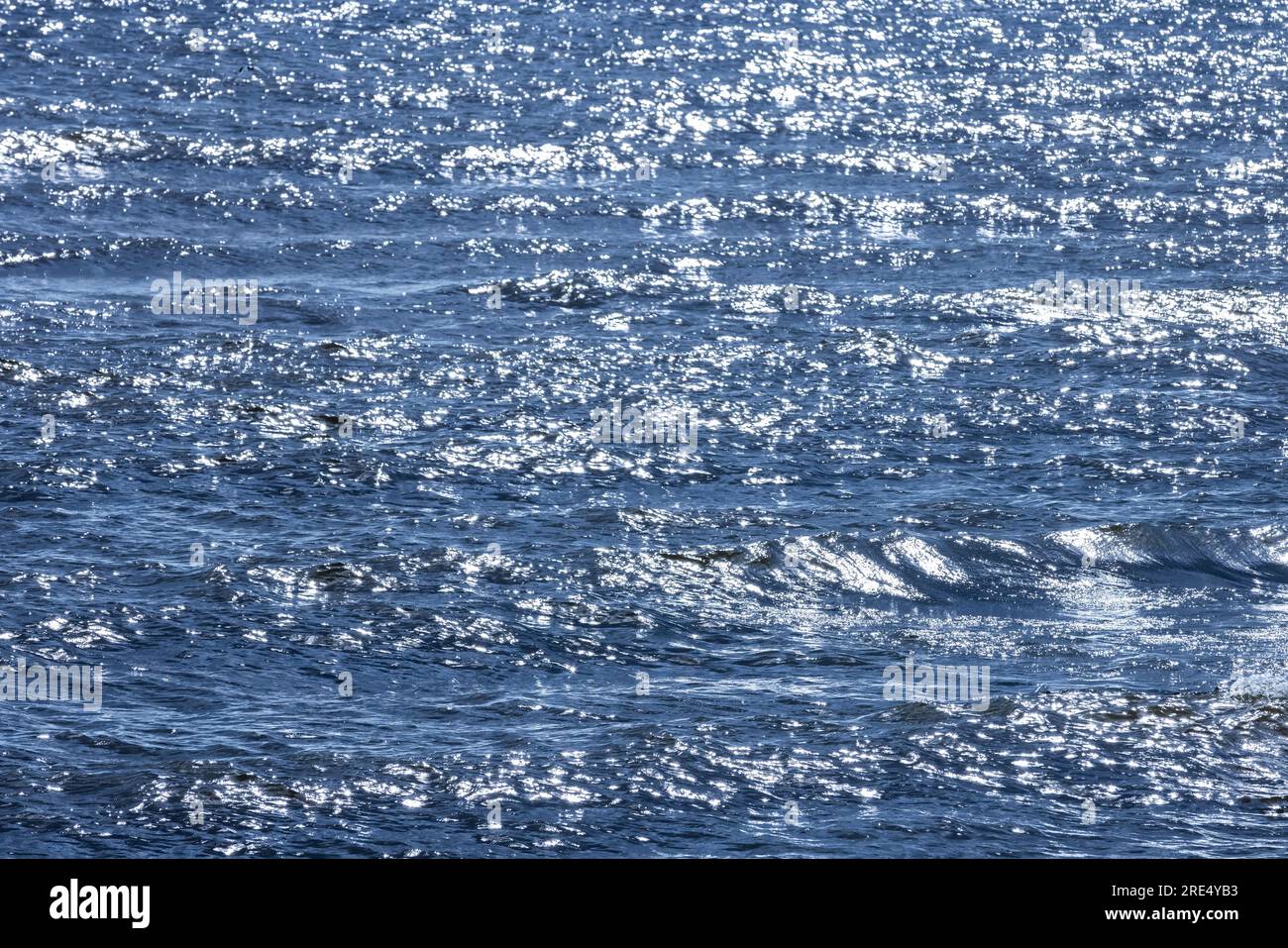 Shiny blue sea water with reflections of sunlight, natural background ...